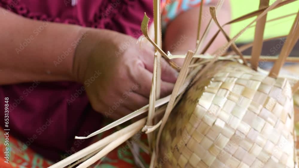 An Indonesian woman´s hand weaving an ancestral basket case from ...