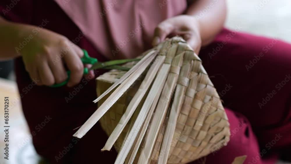 An Indonesian woman´s hand weaving an ancestral basket case from ...