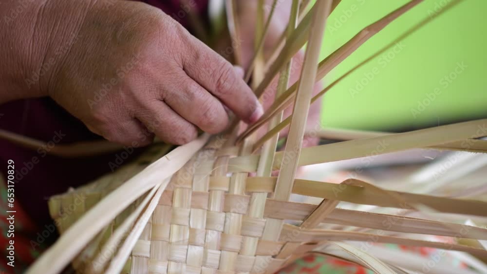 An Indonesian woman´s hand weaving an ancestral basket case from ...