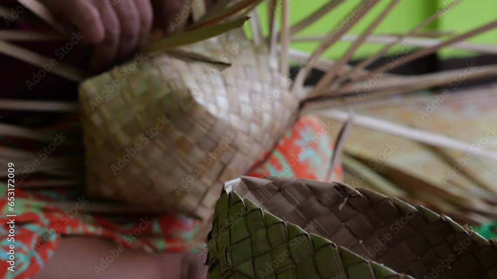 An Indonesian woman´s hand weaving an ancestral basket case from ...