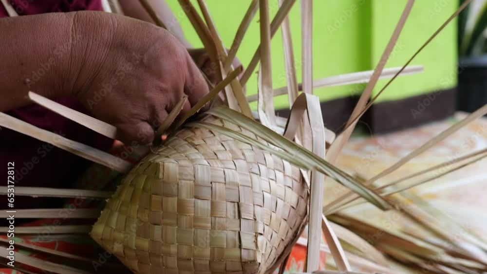 An Indonesian woman´s hand weaving an ancestral basket case from ...