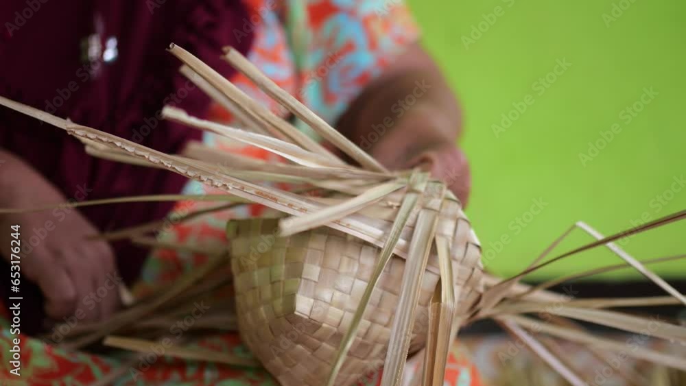 An Indonesian woman´s hand weaving an ancestral basket case from ...