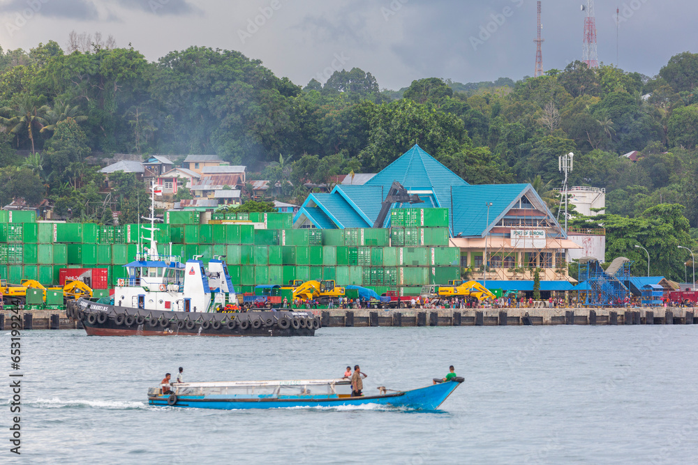 Boat and containers in the harbor in the city of Sorong, the largest ... Boat and containers in the harbor in the city of Sorong, the largest ...