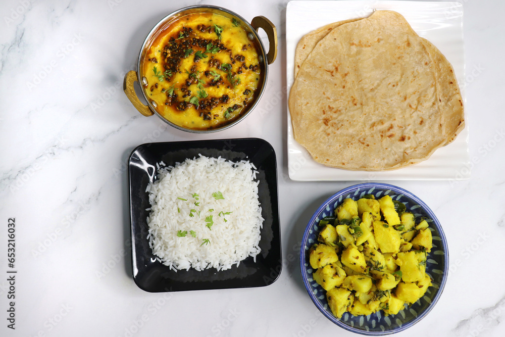 Indian vegetarian Thali or platter includes Aloo ki sabji, dal rice ...