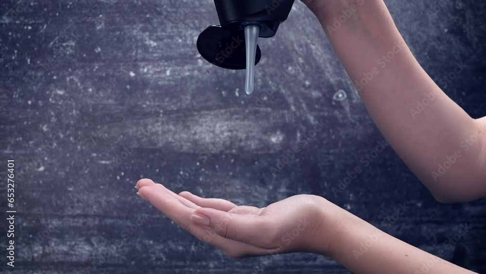 Cleansing body wash in black bottle poured into woman palm. Skin ...