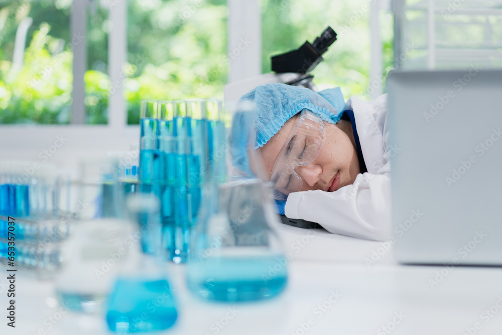 scientist take nap and rest from tired working overtime in laboratory ...