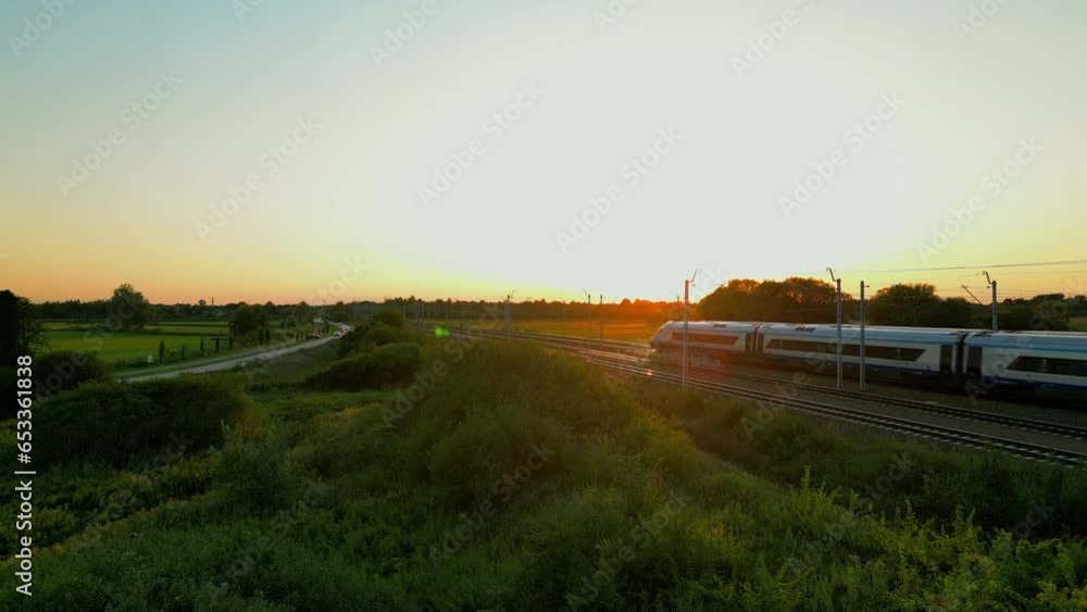 Two high-speed trains pass each other at sunset, high-speed rail and ...