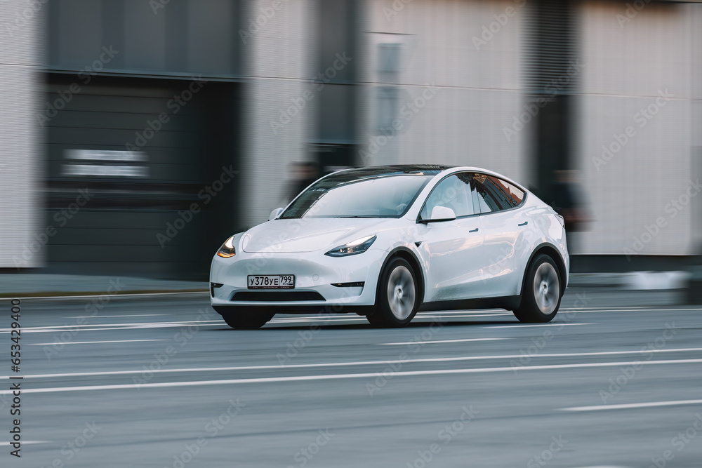 Tesla Model Y all electric car driving down the street Stock Photo ...
