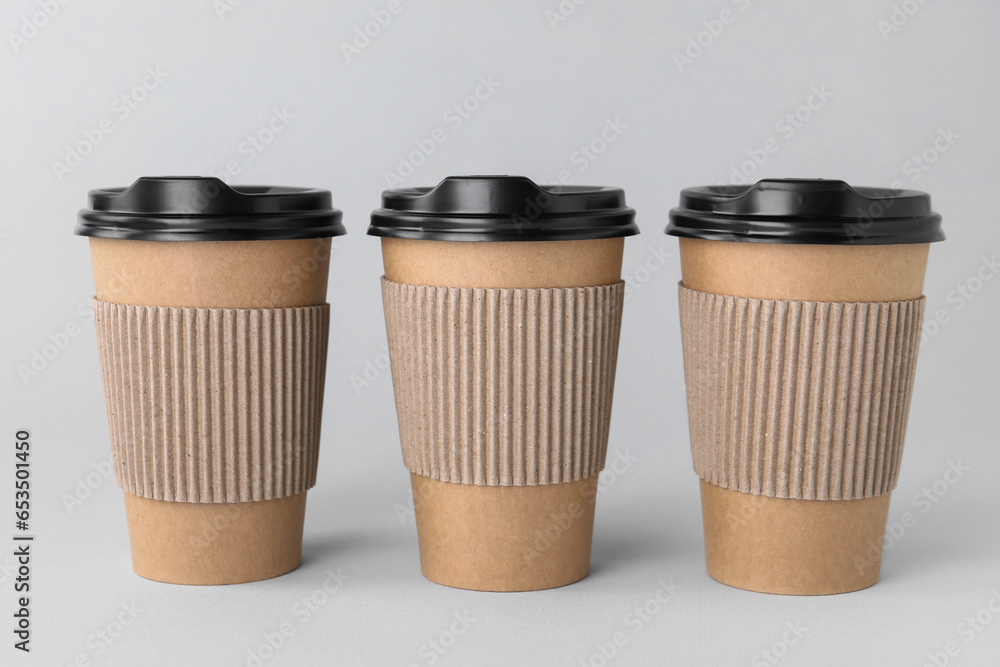 Paper cups with black lids on light grey background. Coffee to go Stock ...