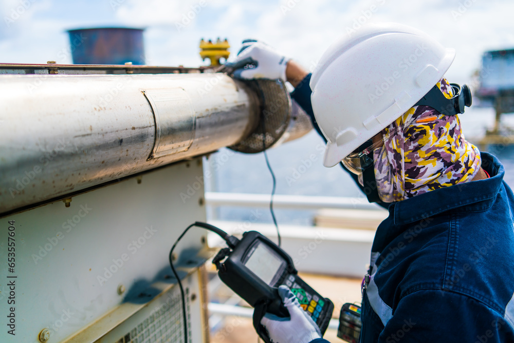 Fotografie, Obraz Technicians check the thickness of pipes and heat ...