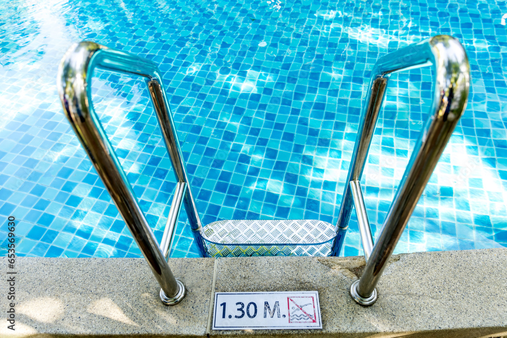 Ladder stainless handrails for descent into swimming pool. Swimming ...