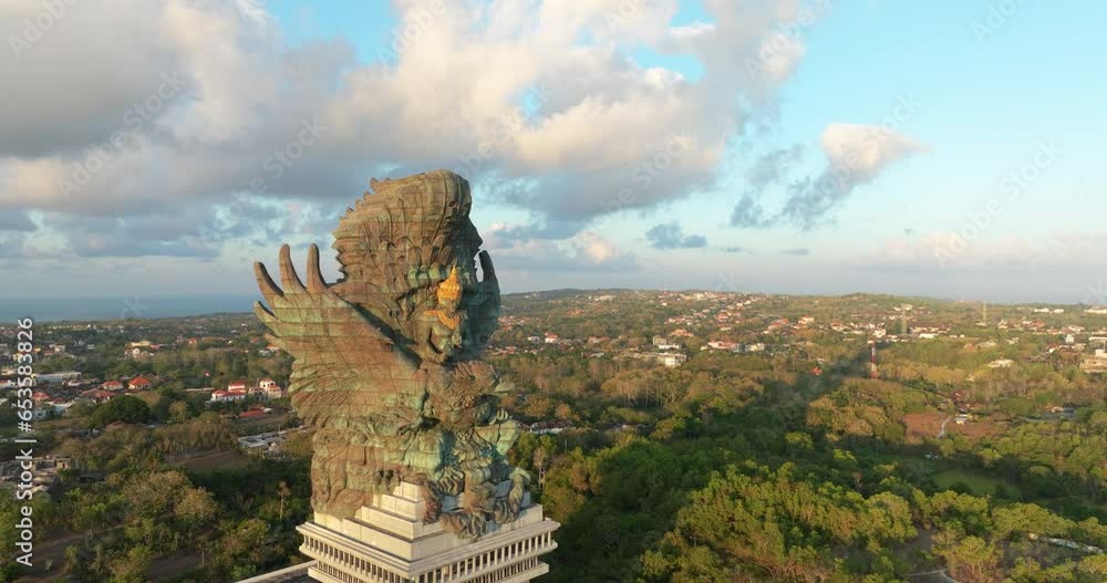 Drone Aerial view 4k Statue of Vishnu in Garuda Wisnu Kencana Cultural Park at sunrise. Bali's ...