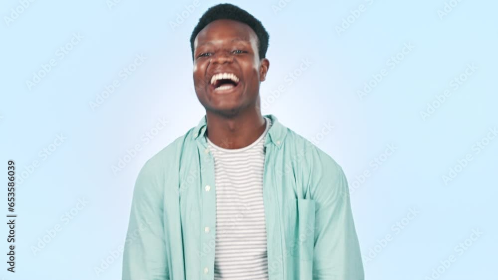 African man, surprise and celebration in studio with blue background ...