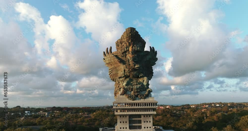 Drone Aerial view 4k Statue of Vishnu in Garuda Wisnu Kencana Cultural Park at sunrise. Bali's ...