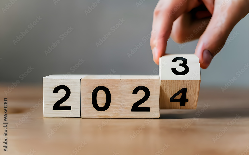 Cube turns from 2023 to 2024 on wooden table. Happy new year 2024 Merry ...
