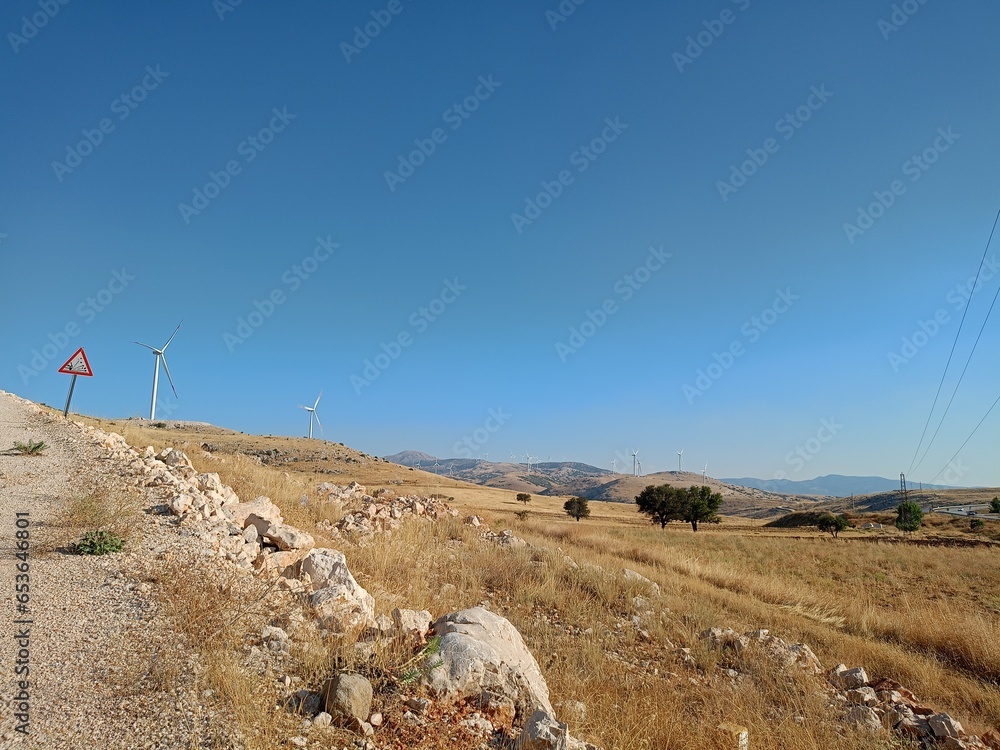 Sustainable energy. Solar farm, wind turbine, and electric pylon with ...
