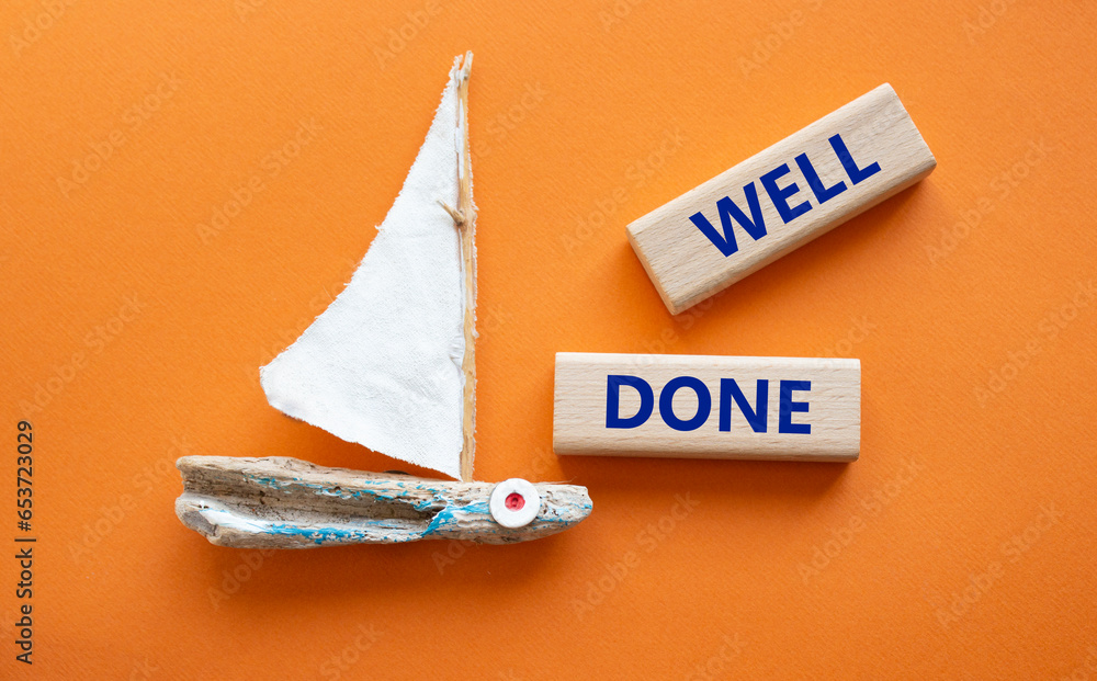 Well done symbol. Wooden blocks with words Well done. Beautiful orange ...