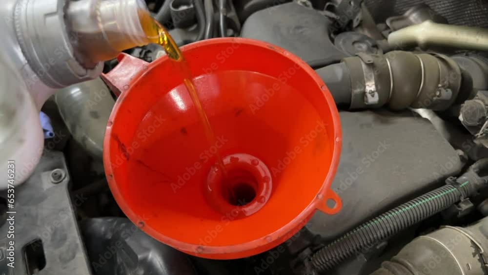 New engine oil is poured into the engine. replacement of technical ...
