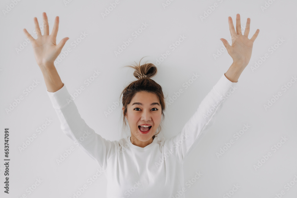 Happy Thai Asian woman bun hair, waving both hands gesture to say hello ...