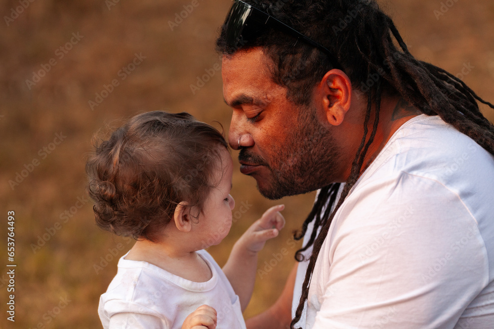 Aboriginal father kissing baby girl Stock Photo | Adobe Stock