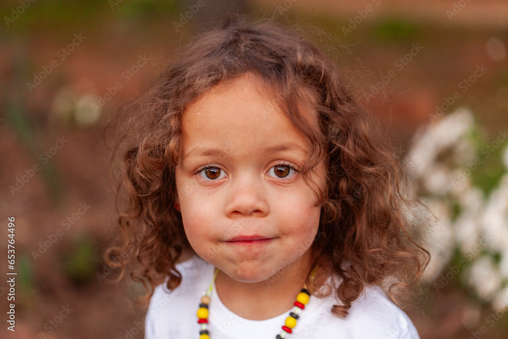 Portrait of curly haired Australian three year old child of aboriginal ...