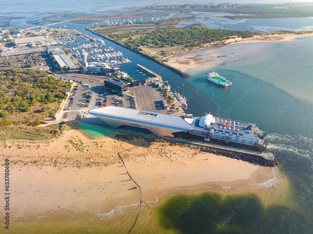 Aerial view of sea ferry at a modern transit terminal alongside a ...