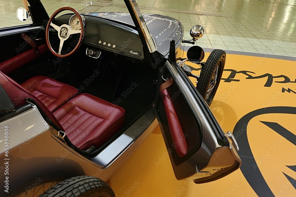 Opened door, leather seats and vintage looking dashboard and driving ...