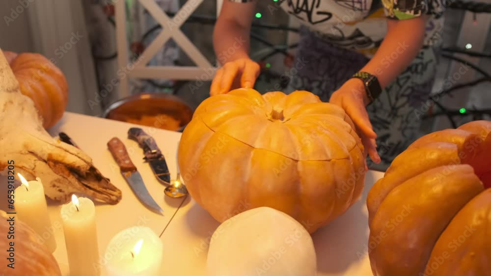 Preparing traditional pumpkins for halloween celebration, woman ...