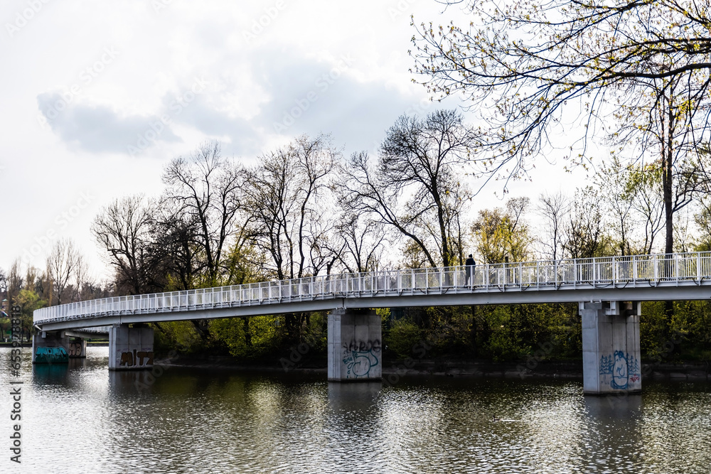 Pedestrian bridge in Bordei park over the lake. Bucharest, Romania ...
