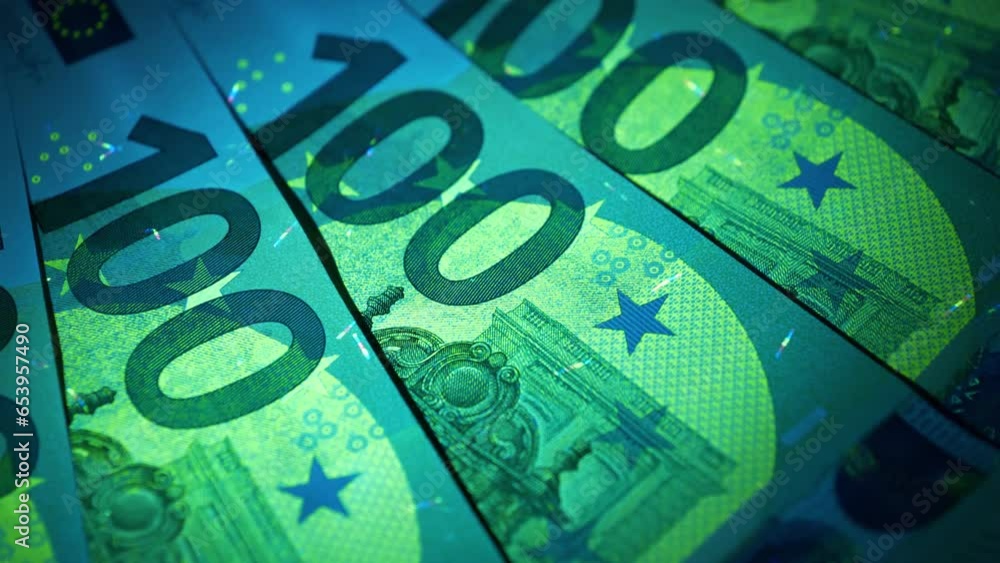Euro banknotes under ultraviolet light. Security signs and elements on ...