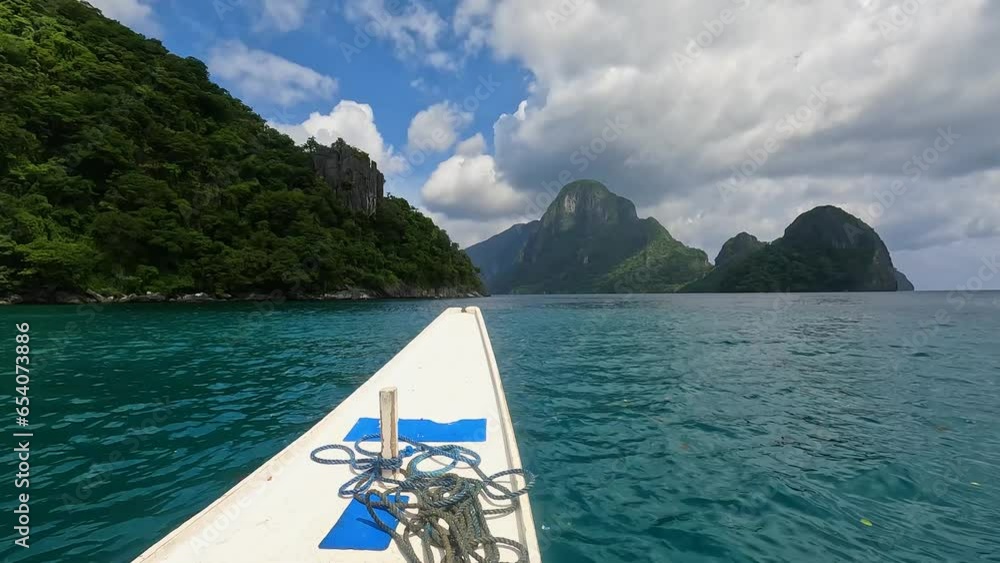 Traveling on boat approaching remote tropical islands on turquoise ...