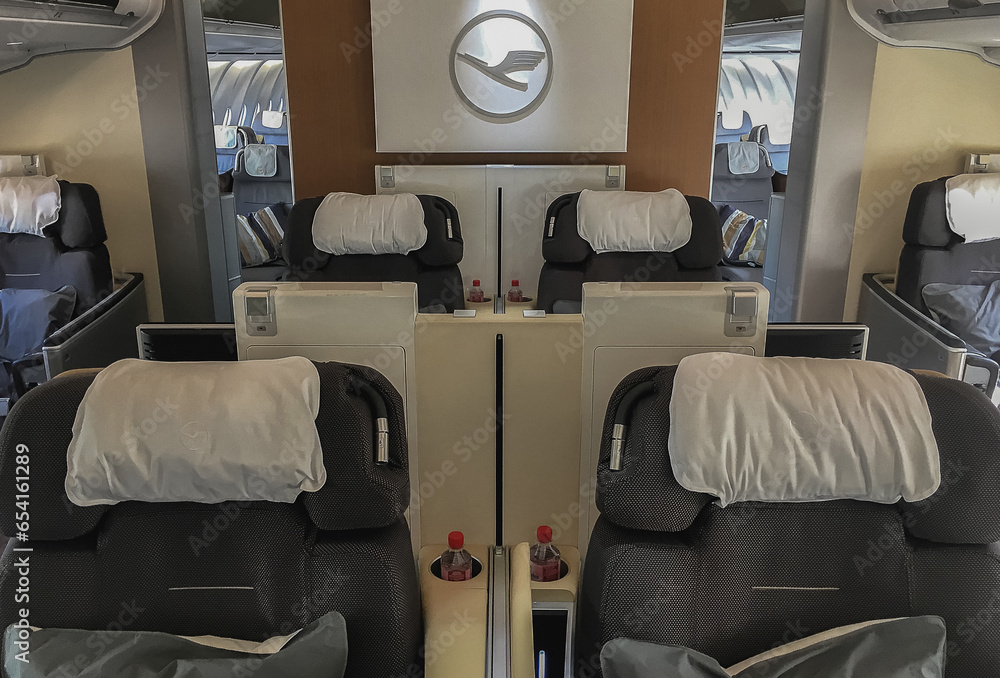 View into First Class cabin with single and double lie flat suite seat ...