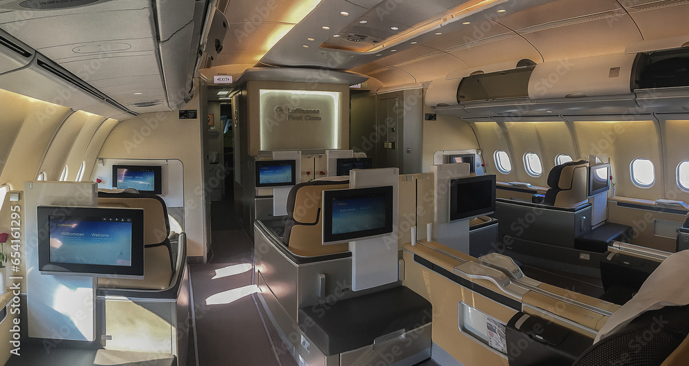 View into First Class cabin with single and double lie flat suite seat ...