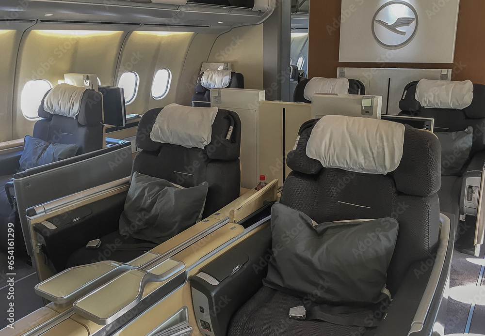 View into First Class cabin with single and double lie flat suite seat ...