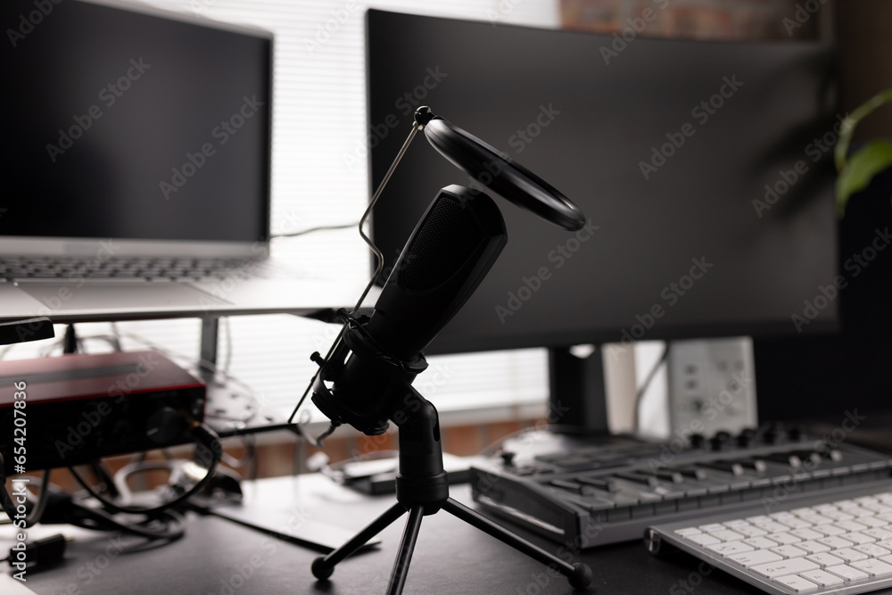 Podcasting set up with computers, keyboard and microphone on desk at ...