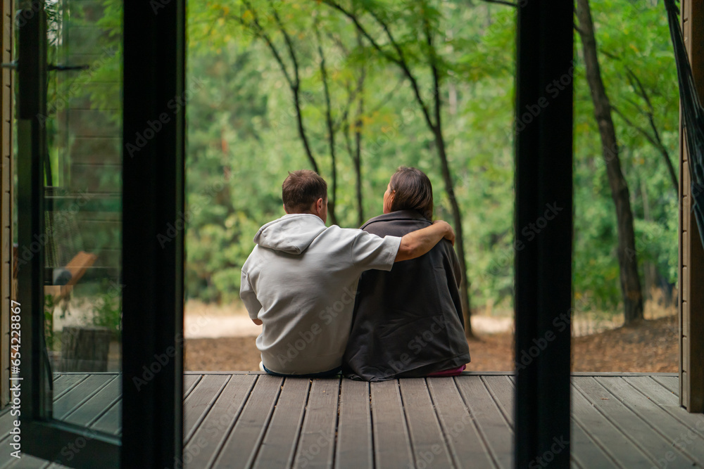 Man and woman in love sitting with their backs to the camera on a ...