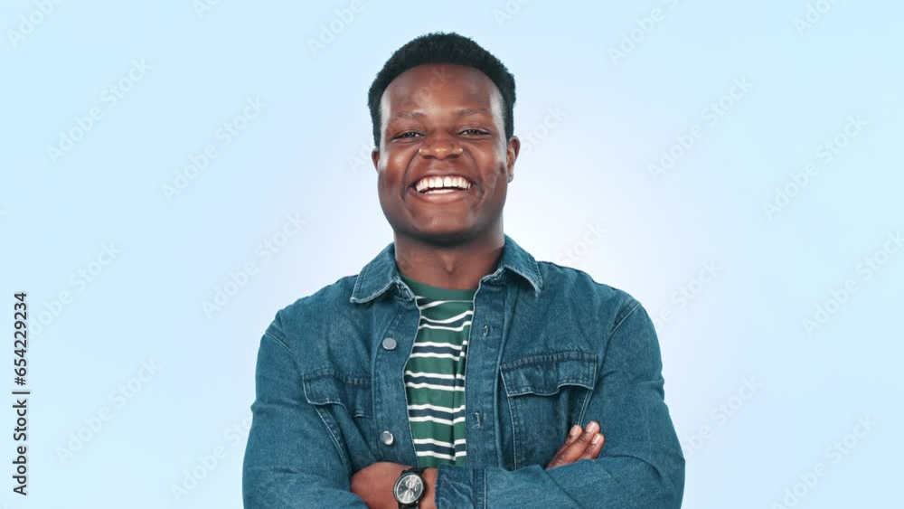 African man, laughing and arms crossed in studio by blue background ...