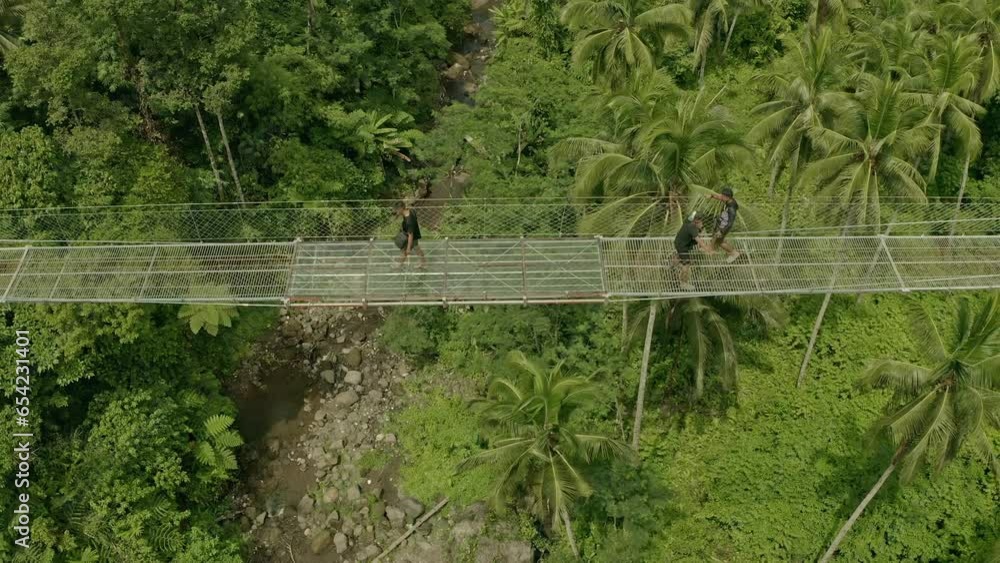 Lumondo Hanging Bridge with Tourists Crossing Over the Jungle Below ...