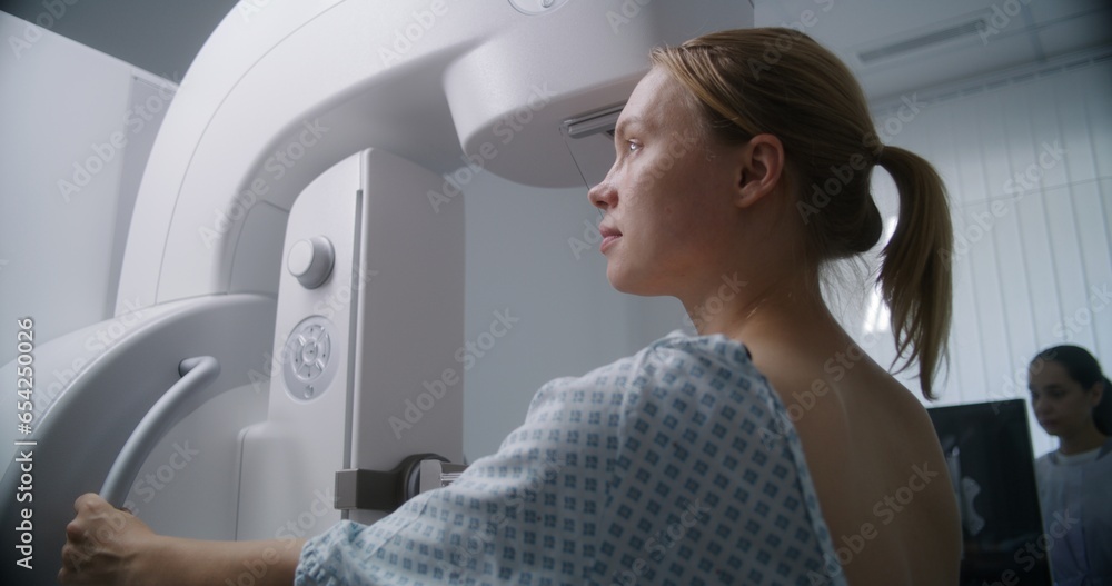 Caucasian adult woman stands in hospital radiology room. Female patient ...