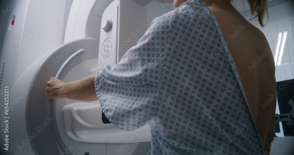Hospital radiology room. Caucasian adult woman stands during ...