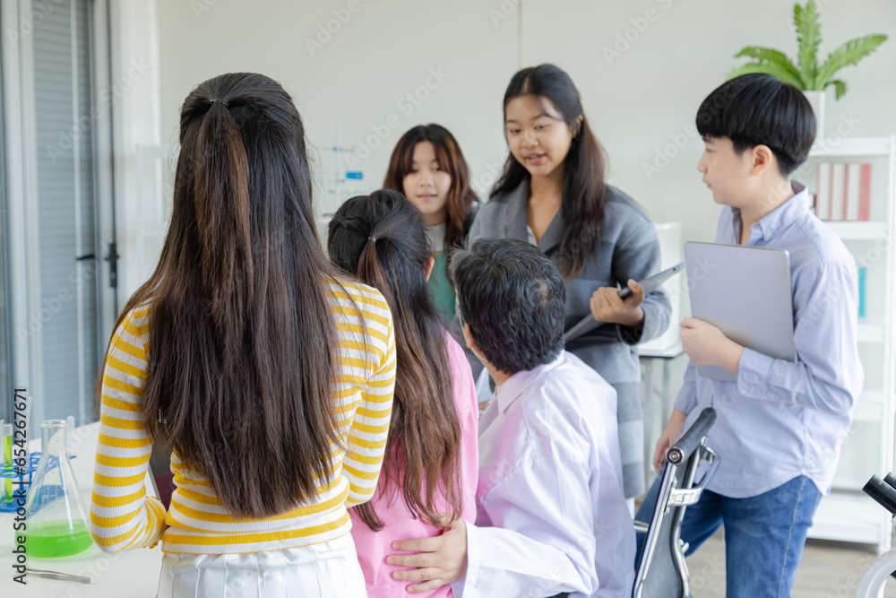 Group of Asian secondary students using technology laptop for studying ...