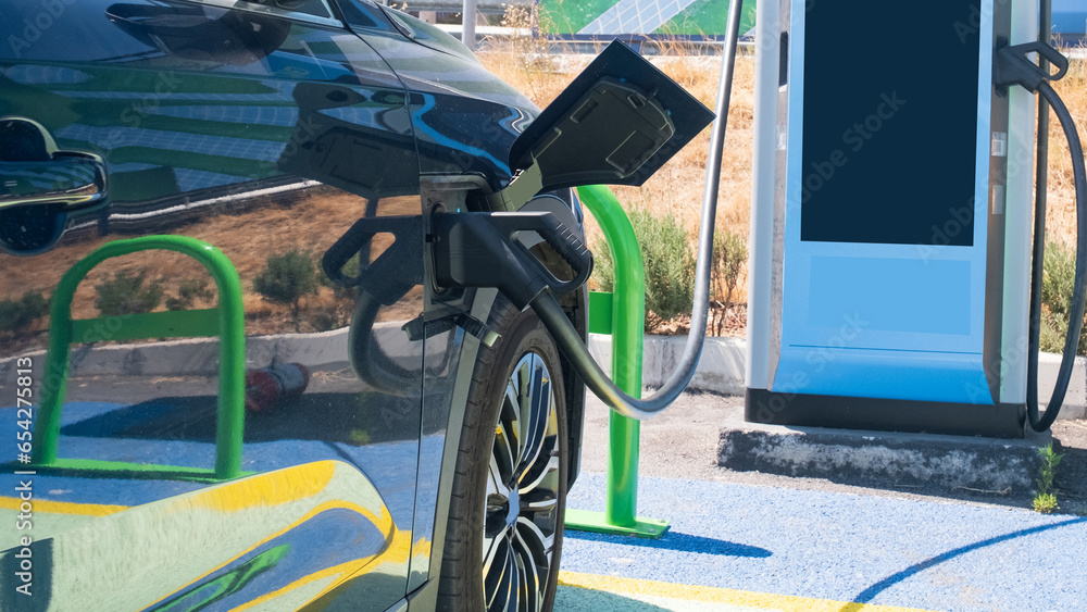 Power cable pump plug in charging power to electric vehicle EV car with ...