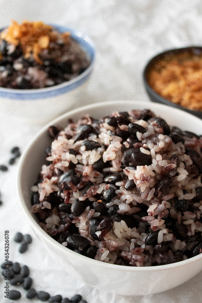 Top view of a bowl of steamed black beans and sticky rice with fried ...