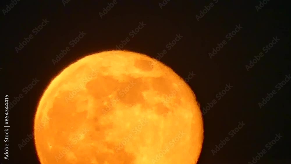 Dark night sky, yellow and orange full moon with Atmospheric refraction ...