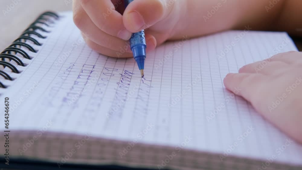 preschool child draws elements with pen in lined notebook, Writing ...