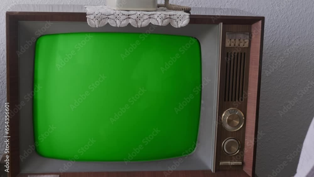 male Hand turns on TV power button, adjusts the volume control old ...