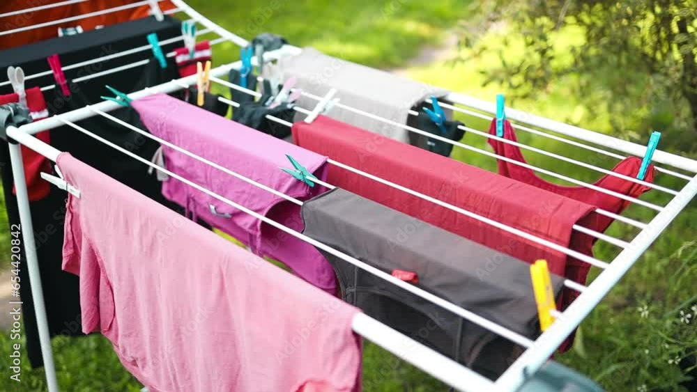 Wet women clothes hanging on clothes dryer. Laundry routine and ...