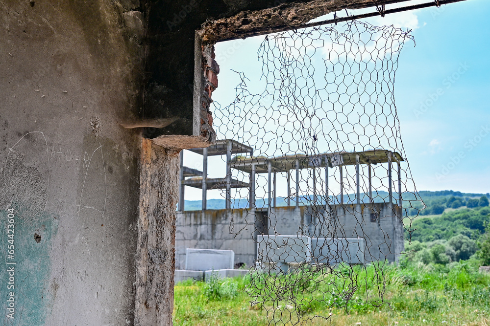 Lost place of an old, collapsed factory hall with concrete wall, look ...