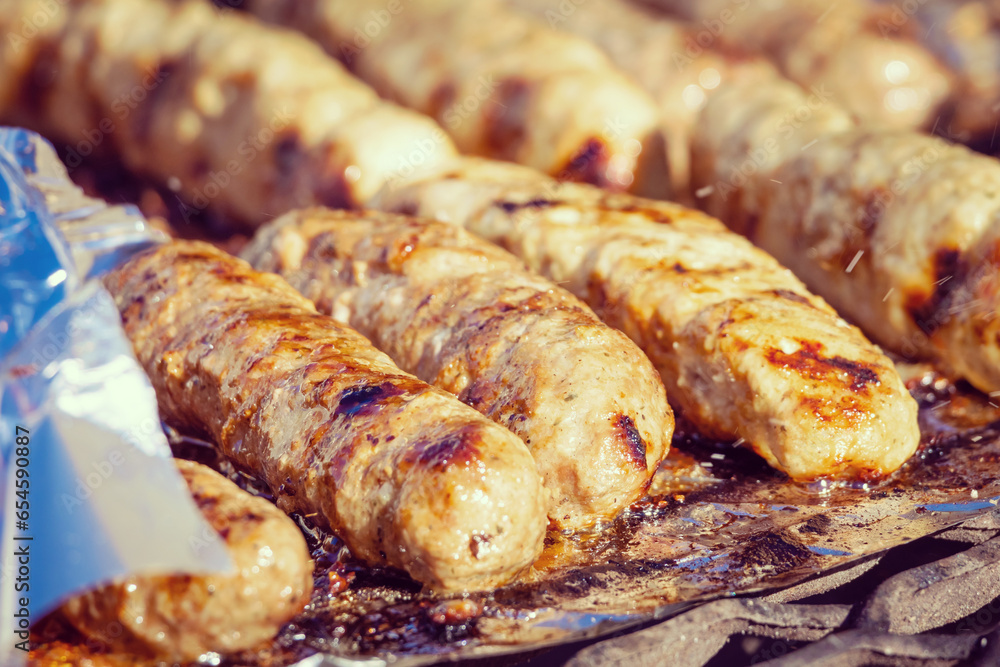 Roasting Lula kebab on an outdoor grill, selected focus. Street food ...
