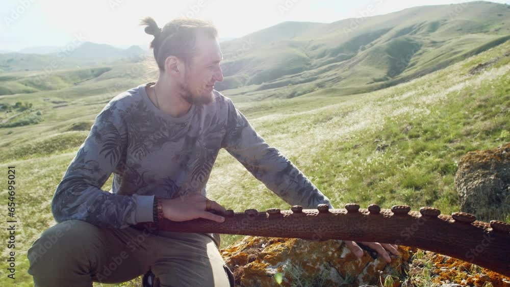 A musician daydreams with an Australian Aboriginal musical instrument ...